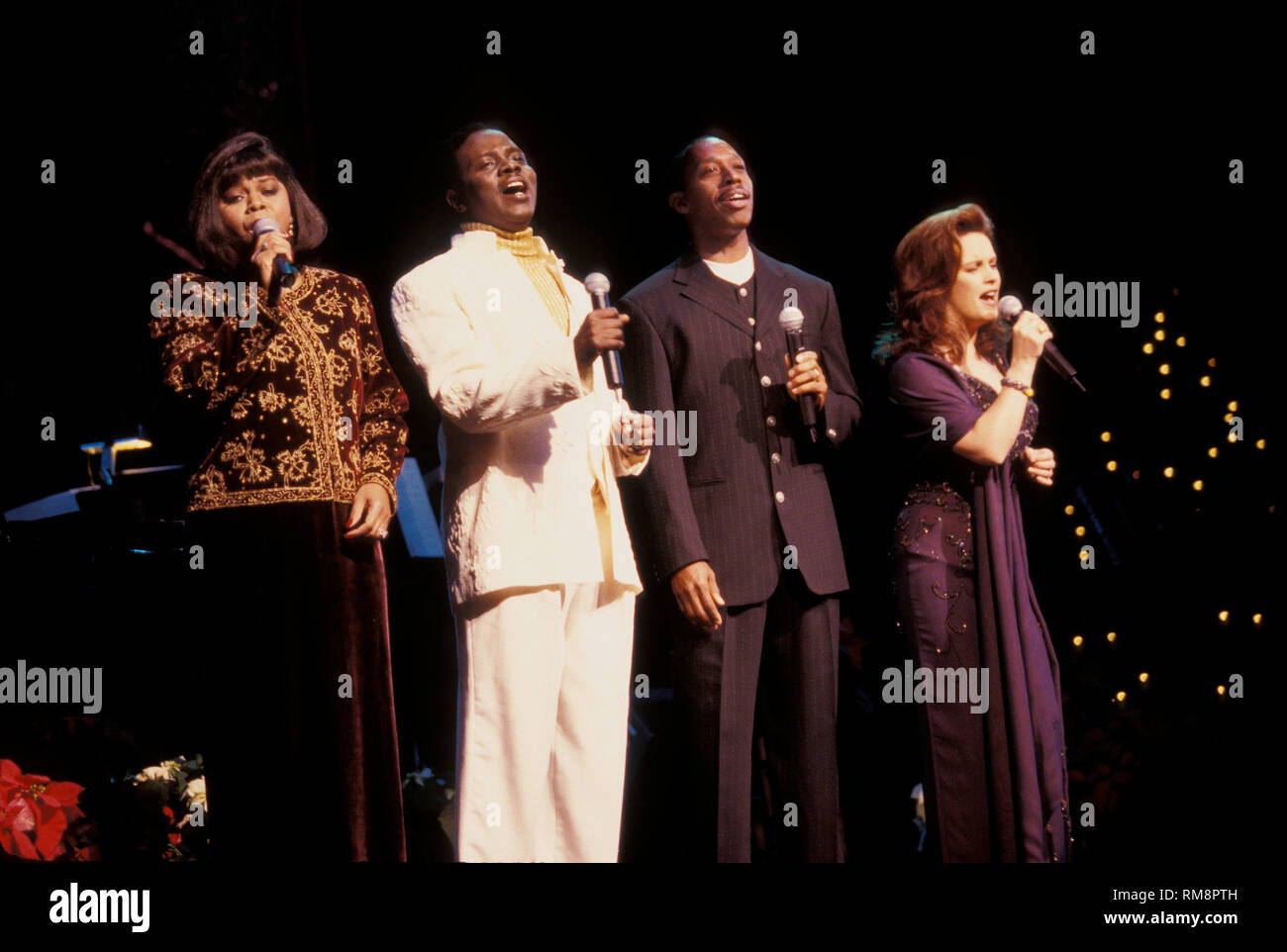 Singer Philip Bailey is shown singing onstage during a concert ...