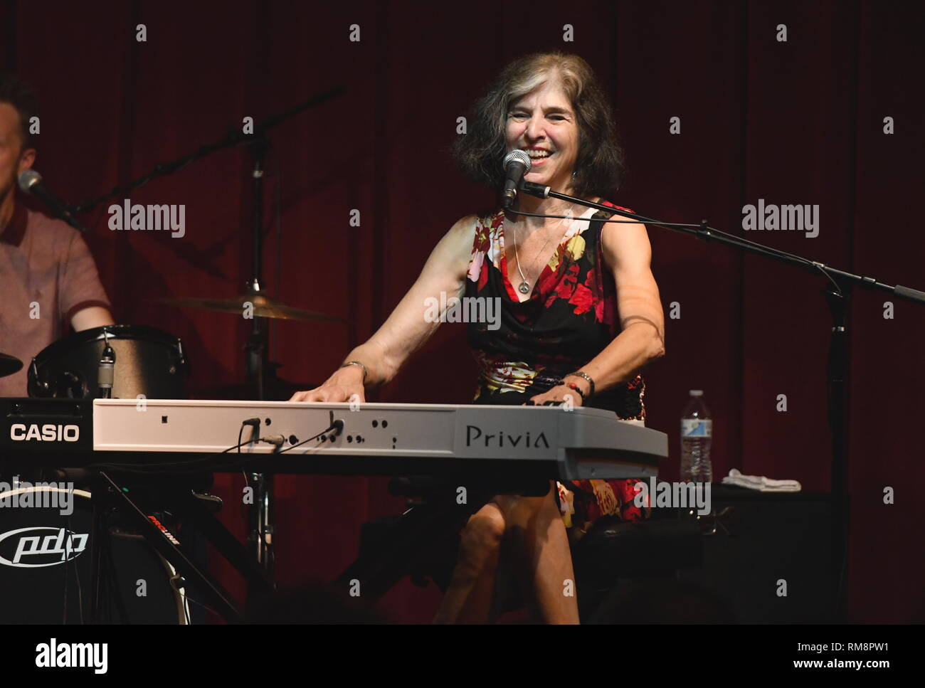 Musician Marcia Ball is shown performing on stage during a "live ...