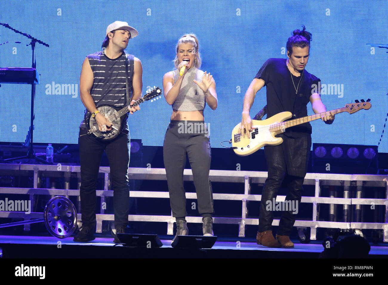 The Band Perry are shown performing on stage during a "live" concert ...