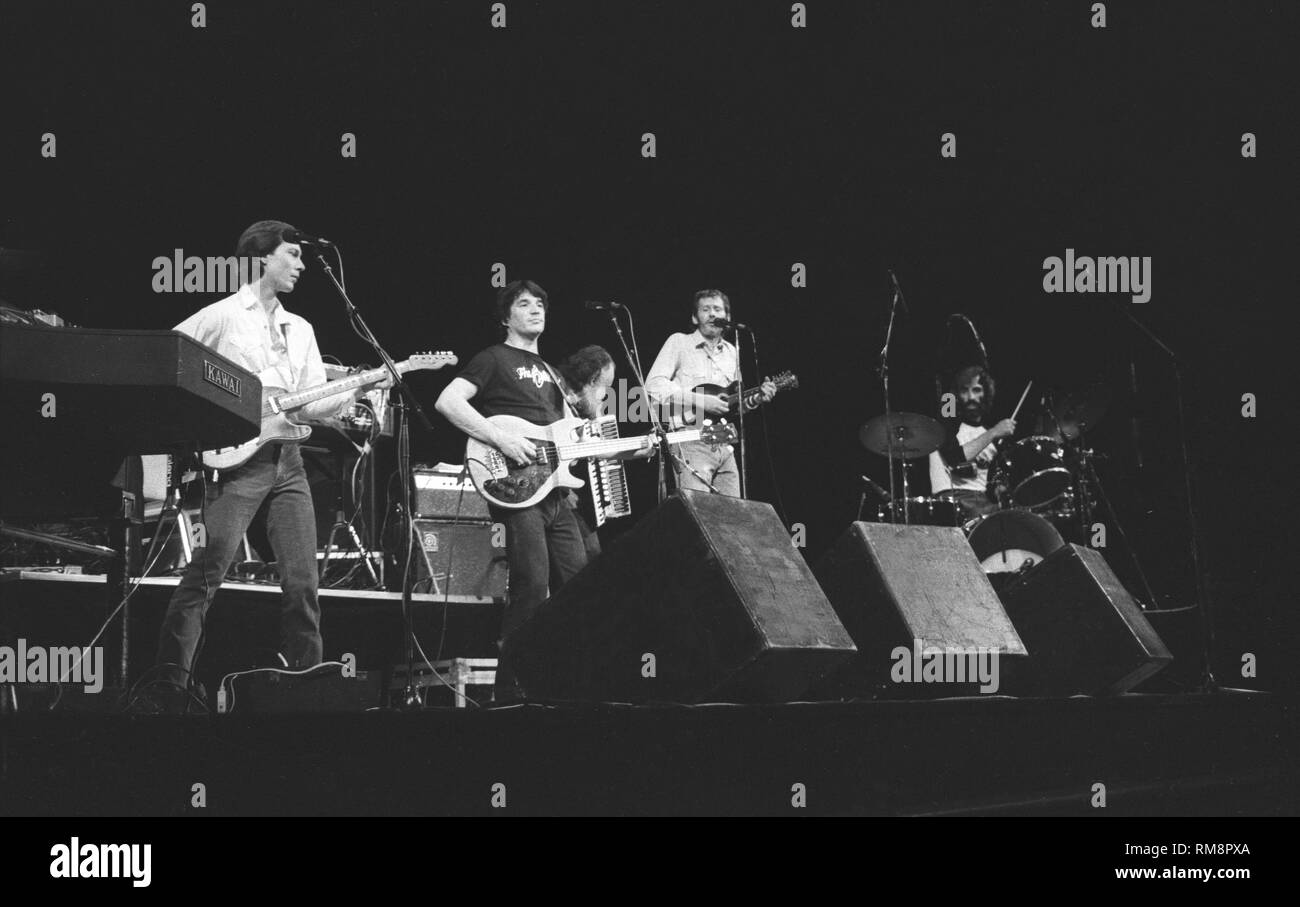 The Band are shown performing on stage during a "live" concert ...