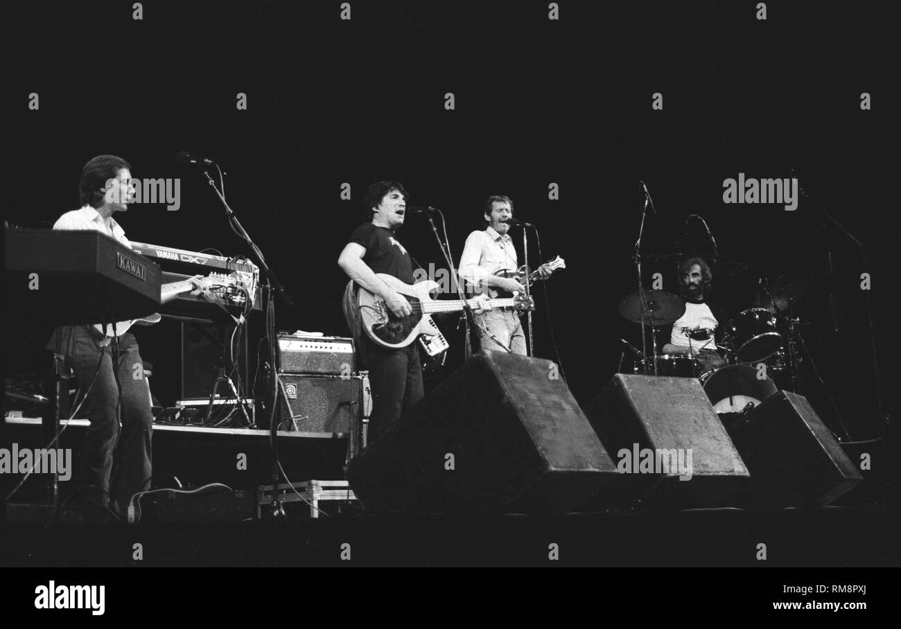 The Band are shown performing on stage during a "live" concert ...