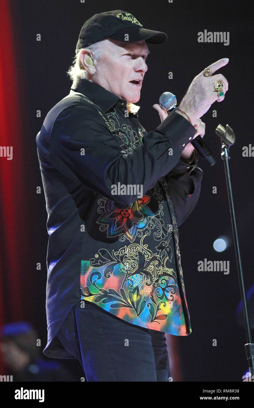 Singer Mike Love is shown performing on stage during a "live" concert ...