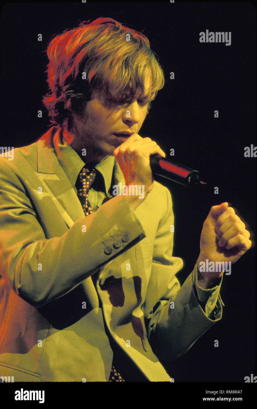Beck is shown performing on stage during a "live" concert appearance ...
