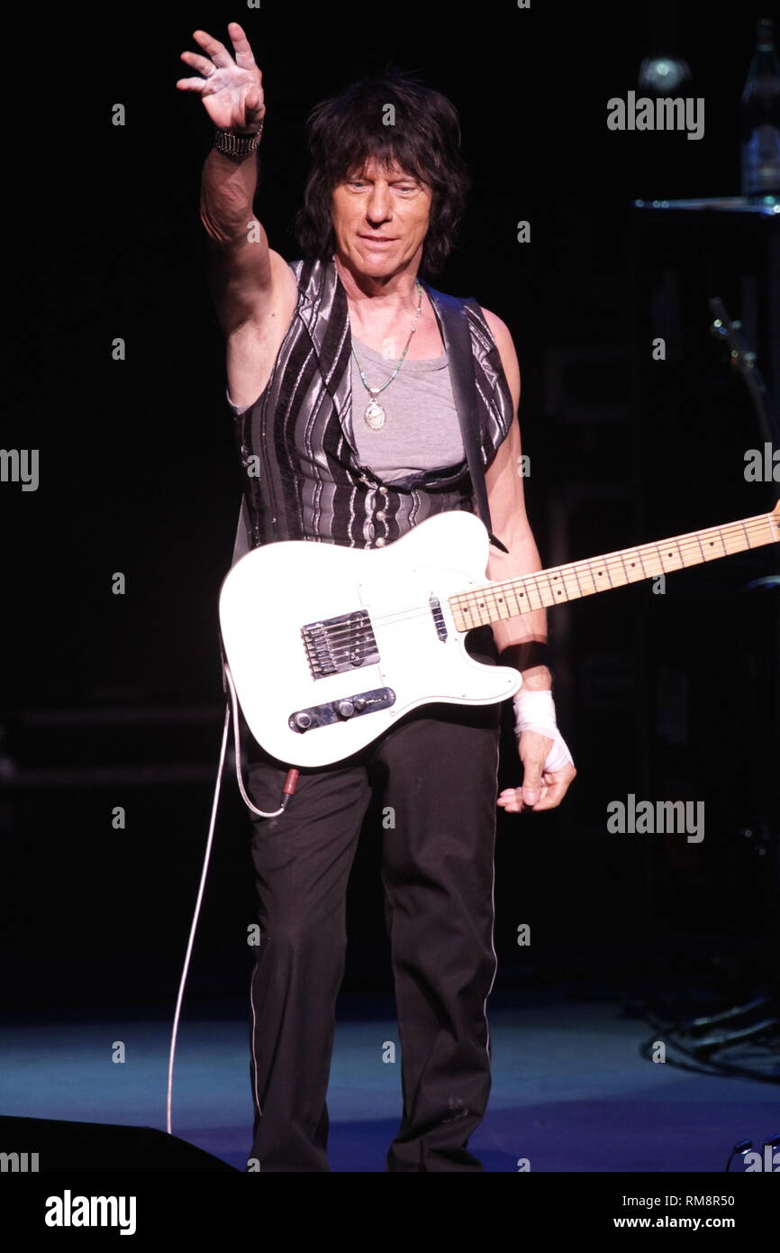 Guitarist Jeff Beck is shown performing on stage during a "live ...