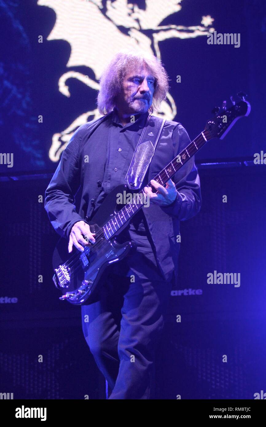 Bassist Geezer Butler is shown performing on stage during a "live ...
