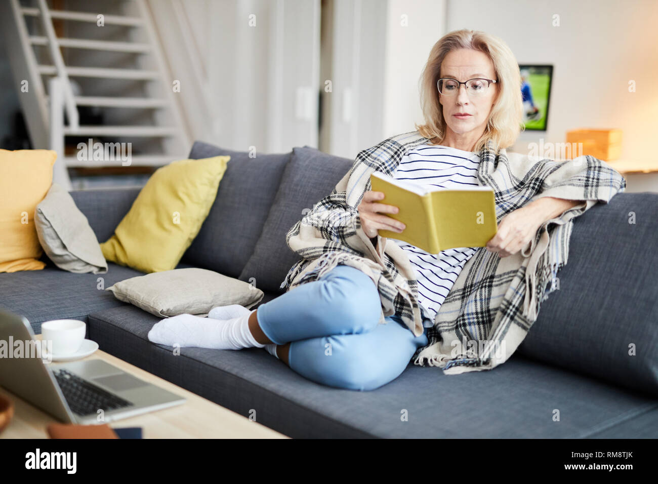 Woman Reading Book at home Stock Photo - Alamy