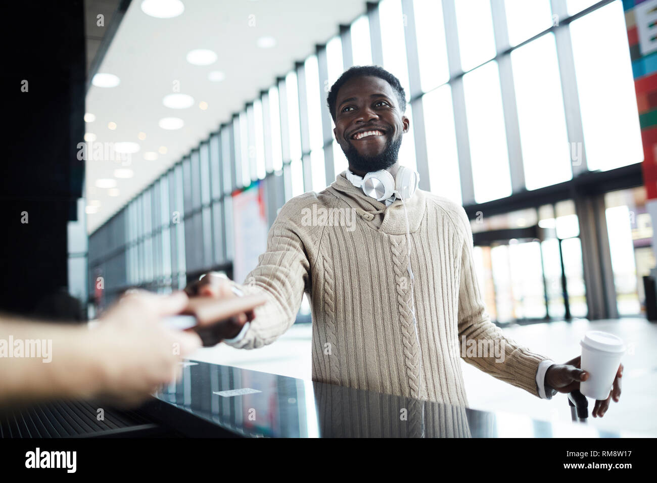 Traveler by check-in counter Stock Photo - Alamy