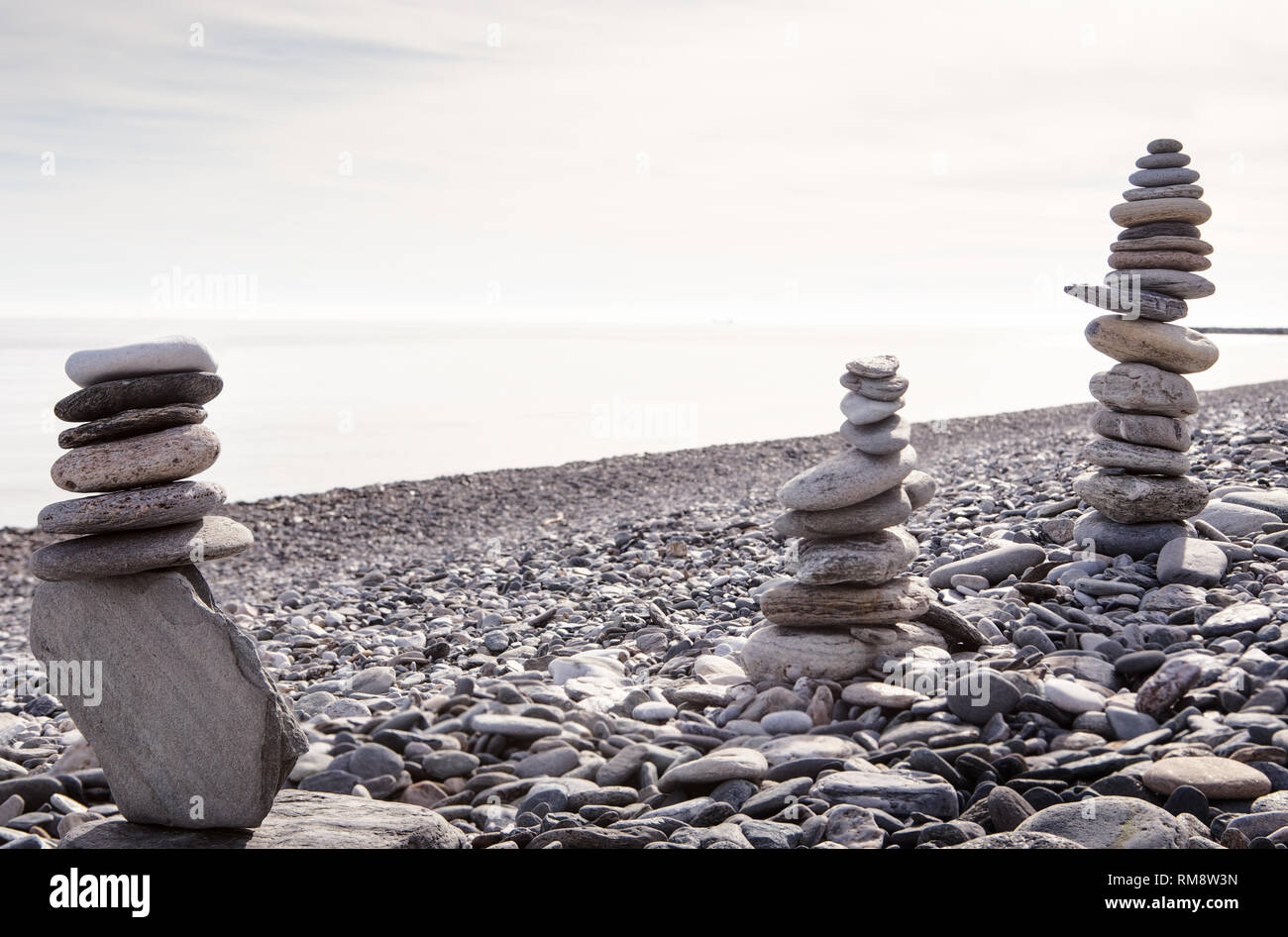 Rock balancing or stone balancin, naturally balanced on a beach with ...