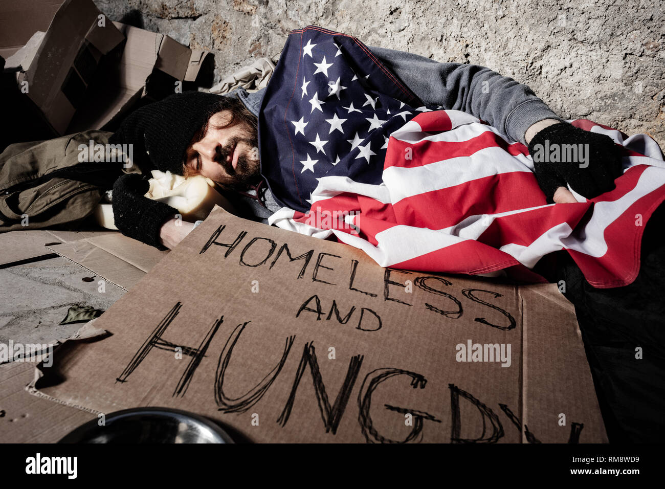Homeless man sleeping outsie under American flag Stock Photo - Alamy
