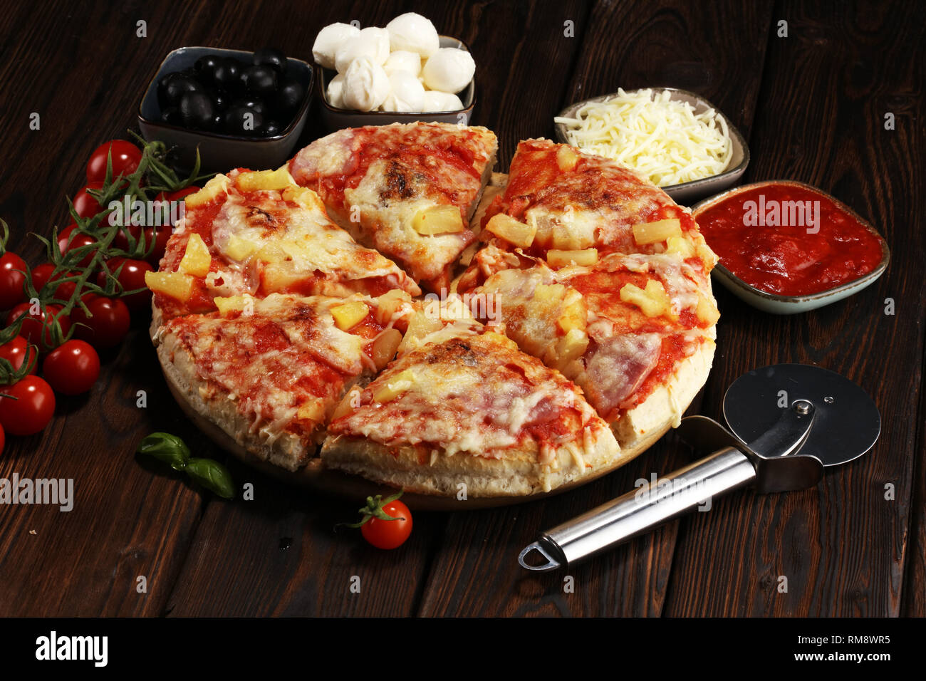 Delicious pizza with pineapple, ham slice, bacon slice, mozzarella ...