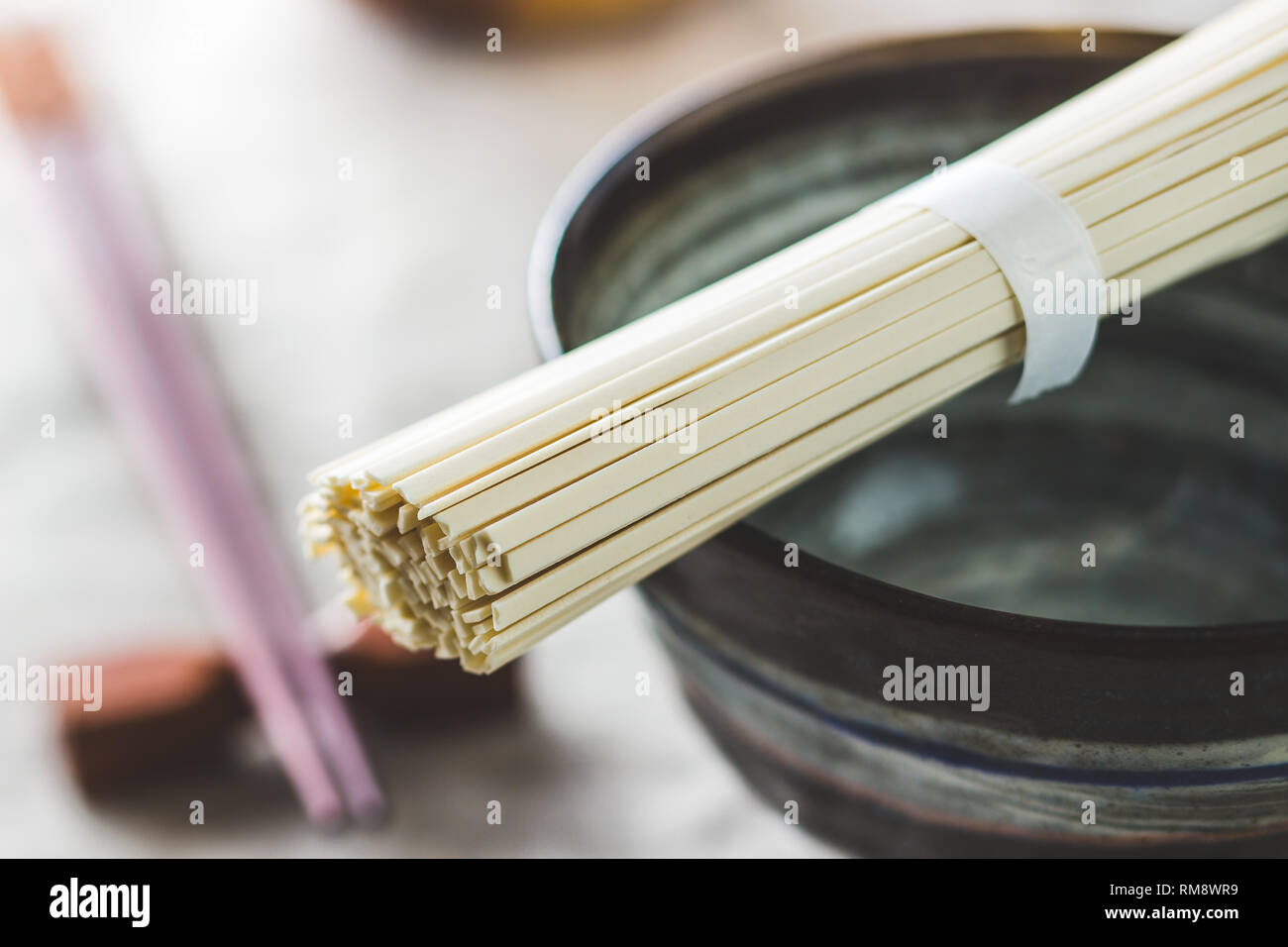 Raw udon noodles on bowl Stock Photo - Alamy