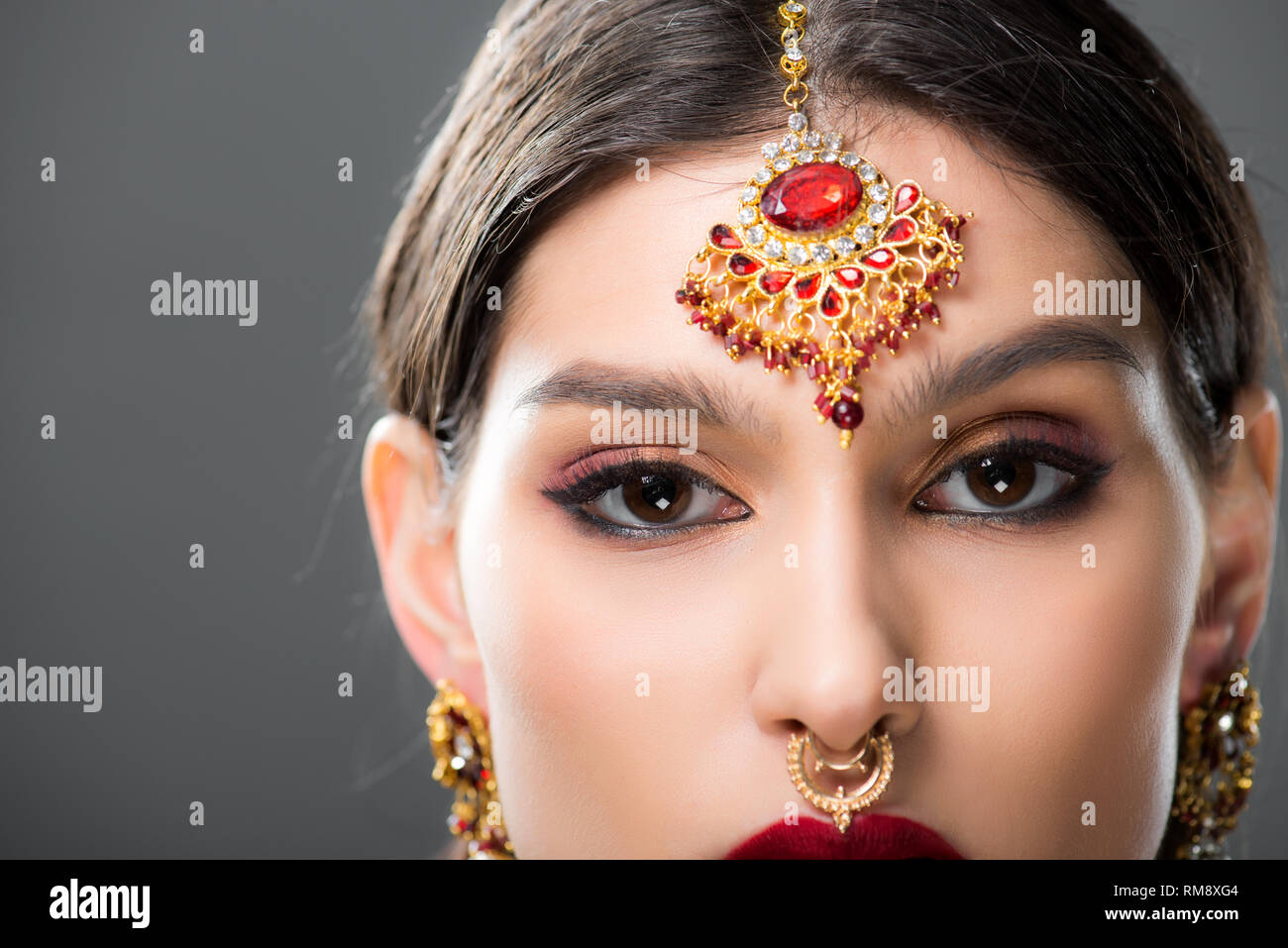 attractive indian woman in traditional bindi, isolated on grey Stock ...