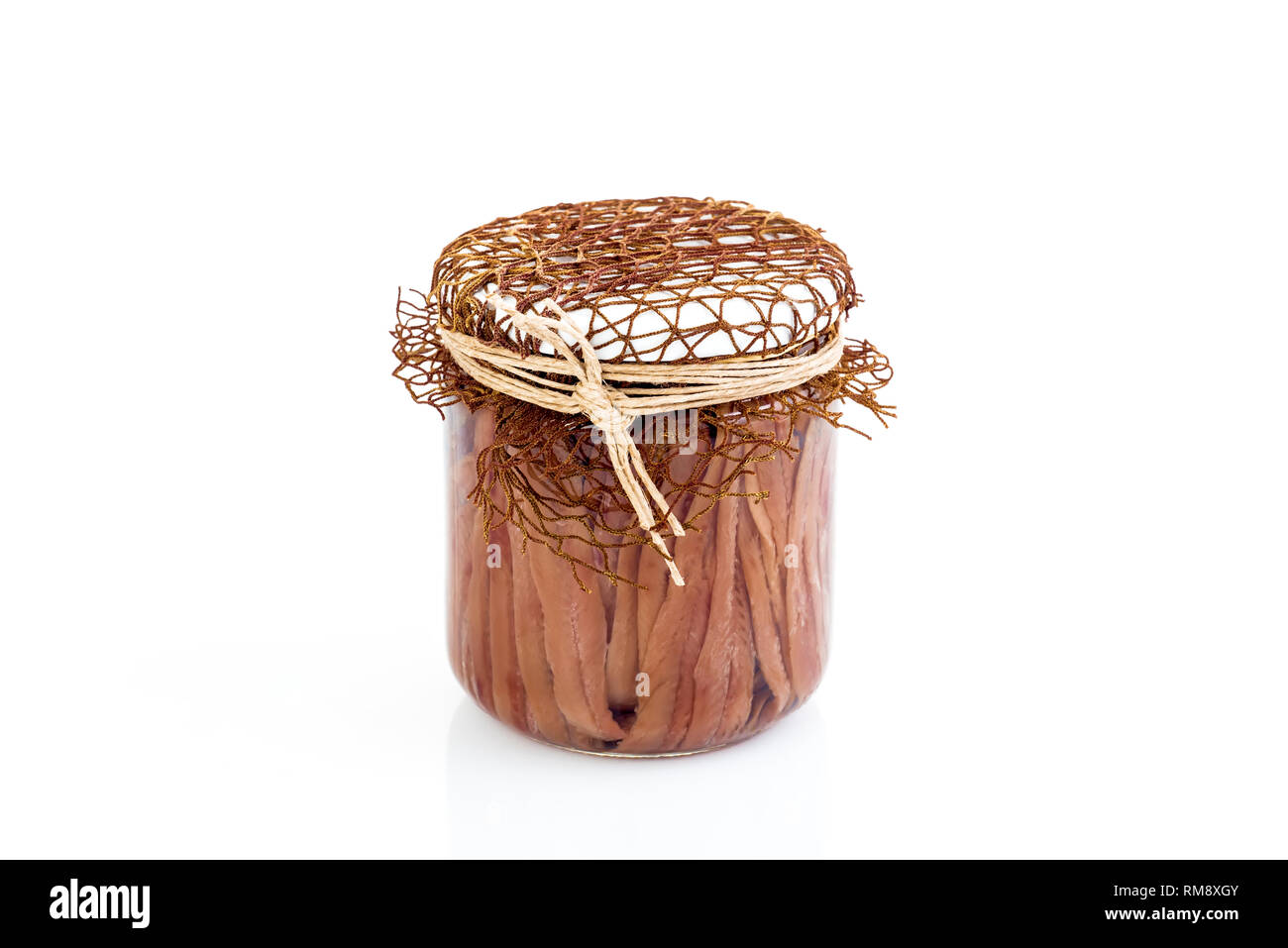 Anchovy fillets in olive oil in a transparent glass jar. Full jar of ...