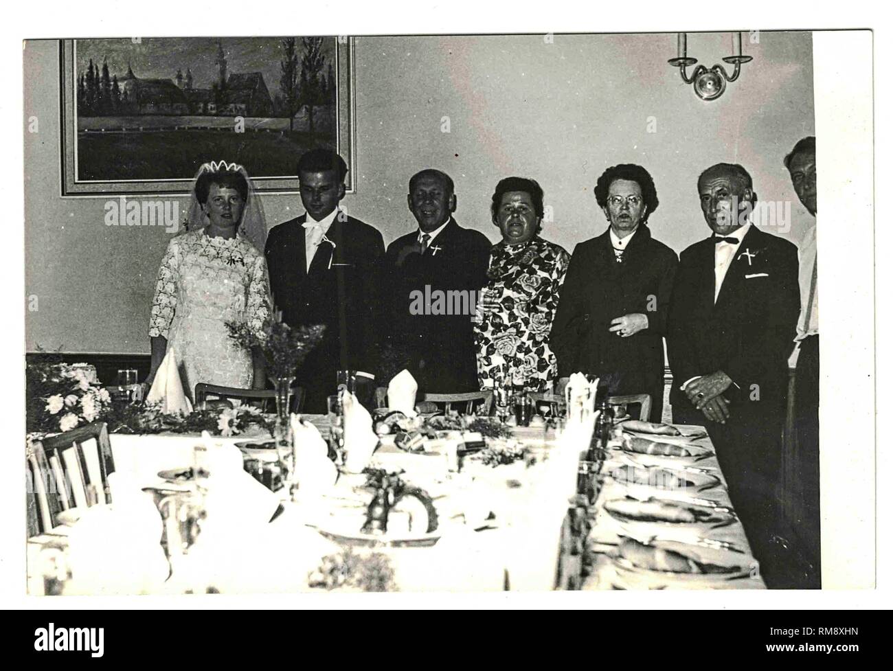 Vintage photo shows newlyweds and wedding guests posing at wedding ...