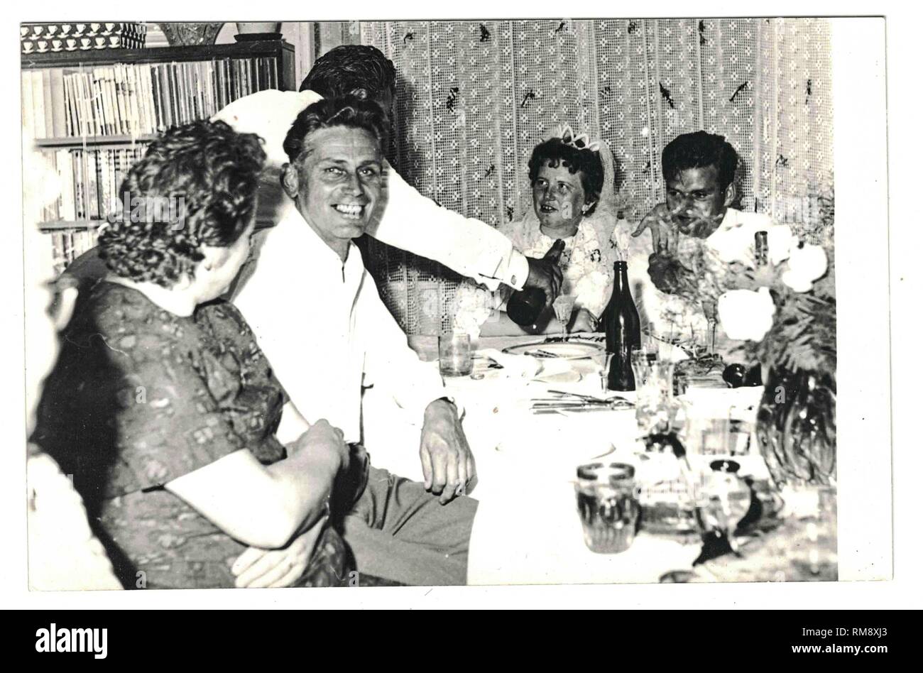 Vintage photo shows newlyweds and wedding guests sitting at wedding ...