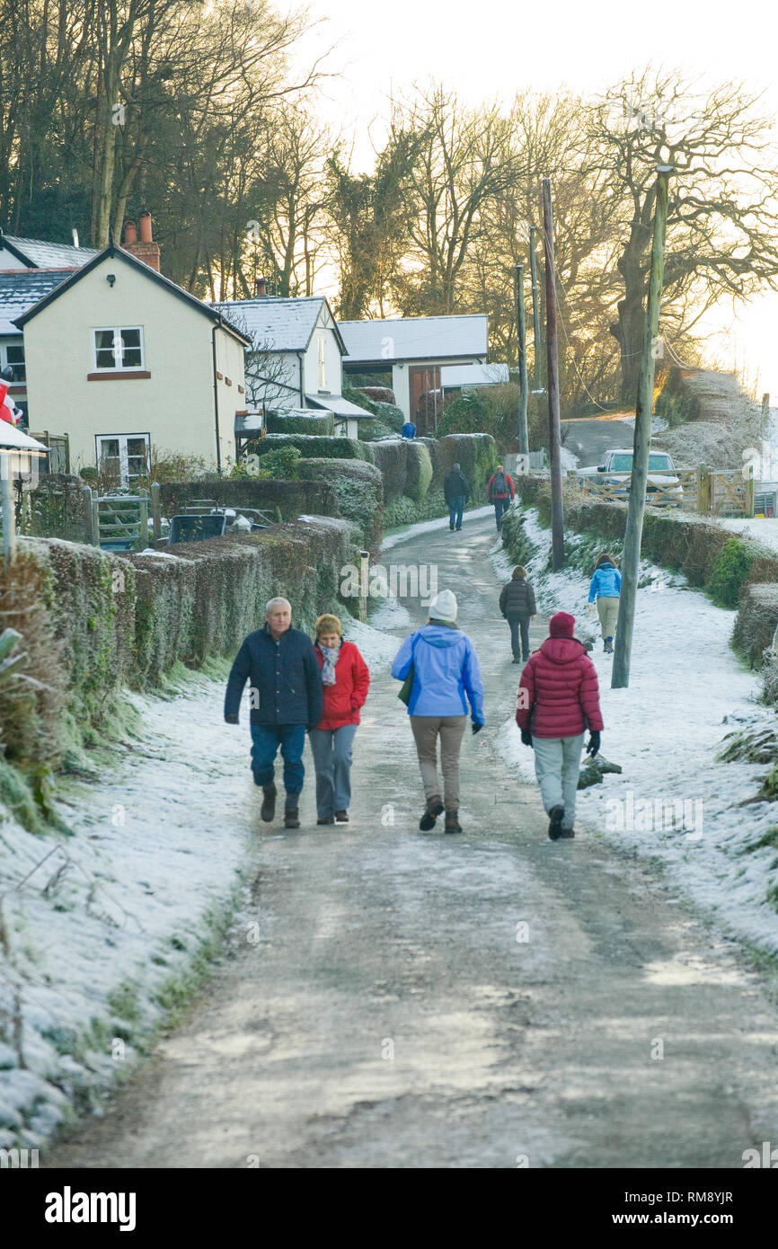 People walking in the Cheshire countryside in snow during winter near ...