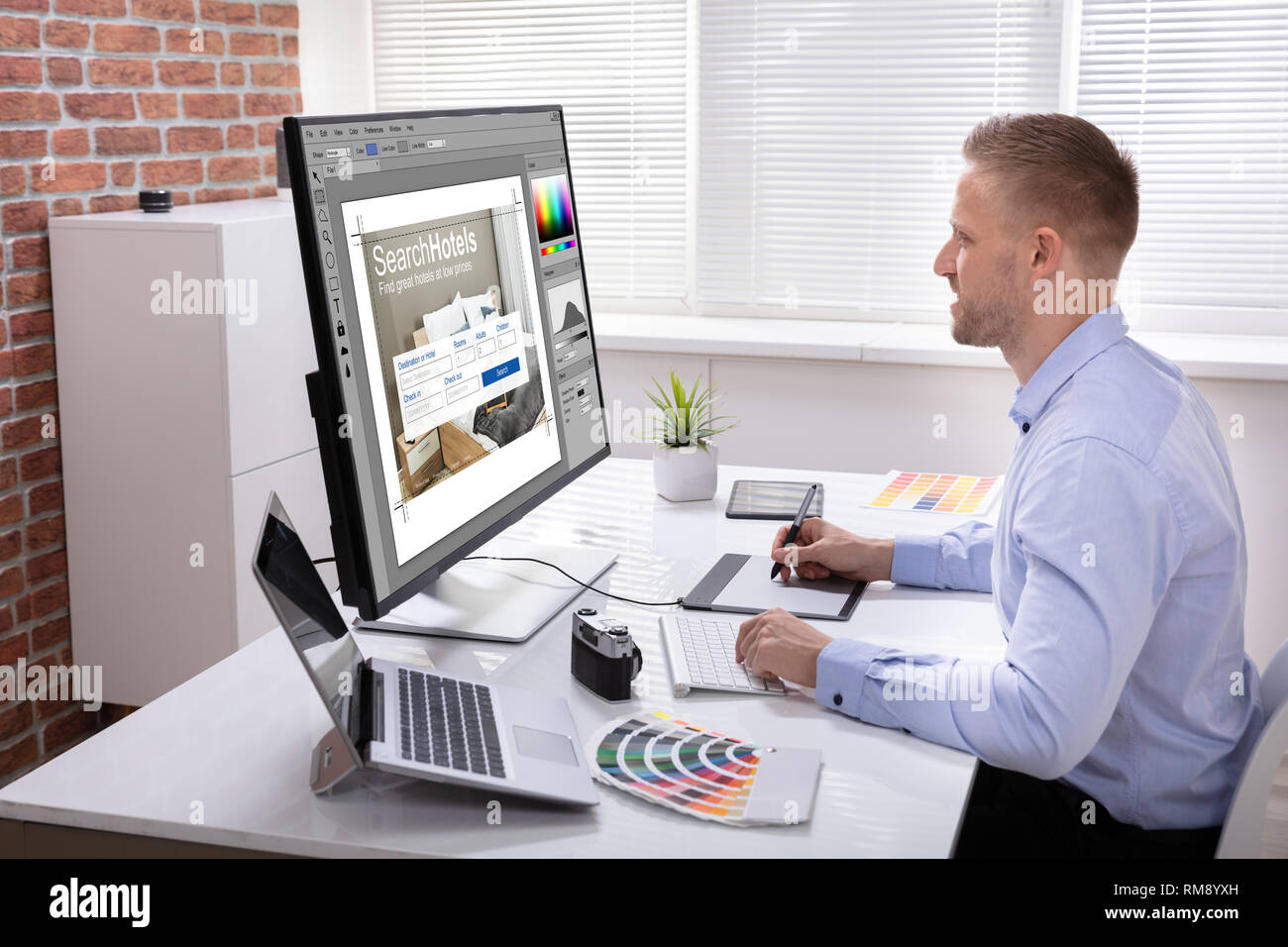 Male Designer's Hand Using Graphic Tablet While Working On Multiple ...