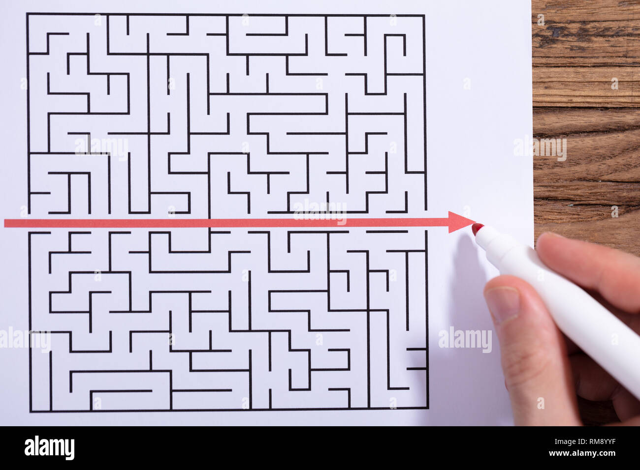 Close-up Of Person's Hand Solving Maze Puzzle With Red Marker Over ...