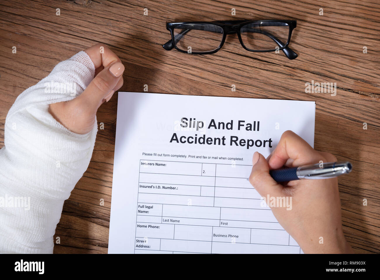 An Overhead View Of Woman With Factured Hand Filling The Slip And Fall ...