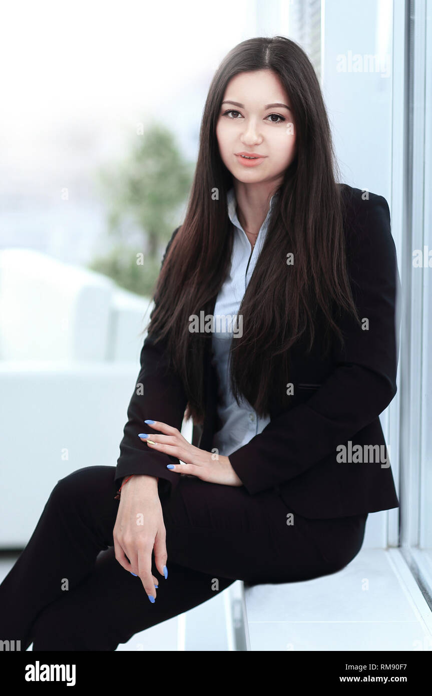 young employee sitting near a window in the office Stock Photo - Alamy