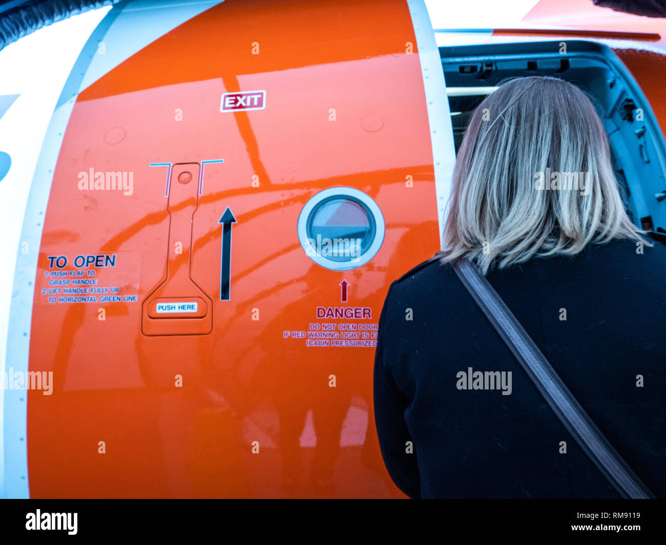 Basel, Switzerland - Nov 11, 2017: Rear view of woman entering the tail ...