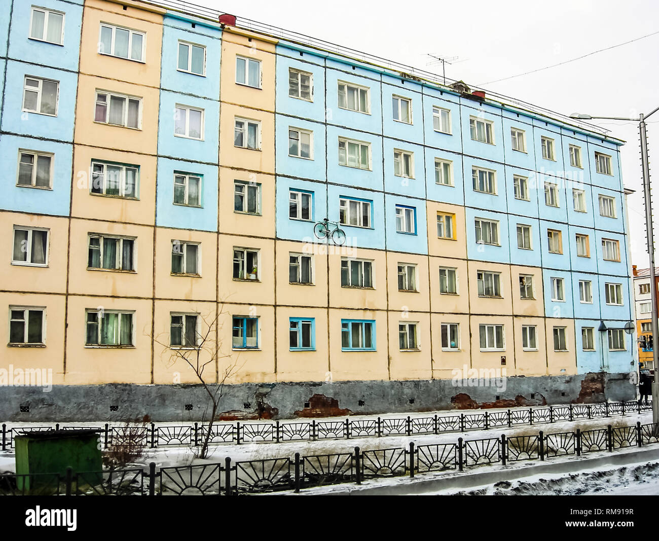 Bicycle, hanging on the wall of the storey building. Five-story house ...