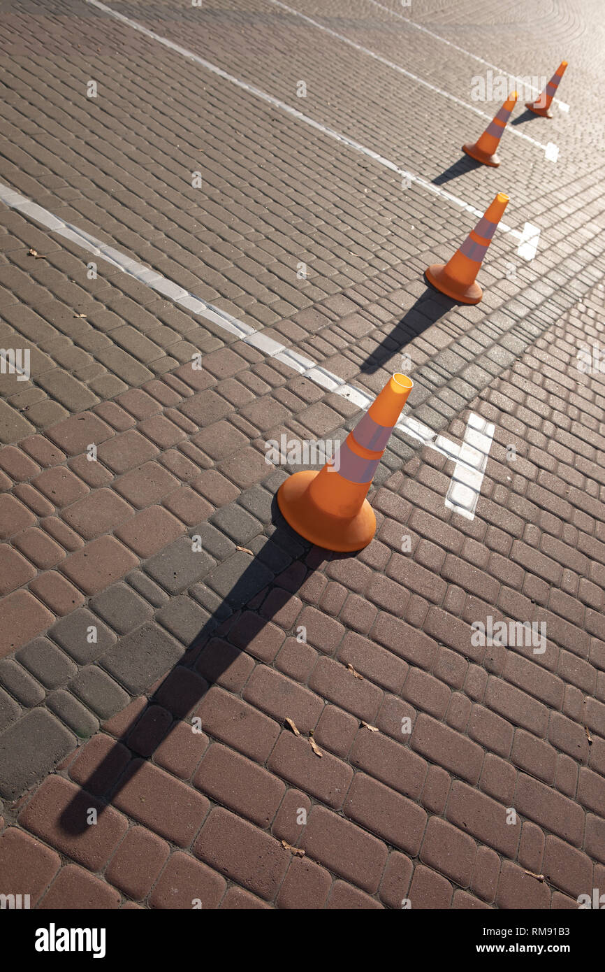 Orange traffic cones standing in a row near the parking Stock Photo - Alamy