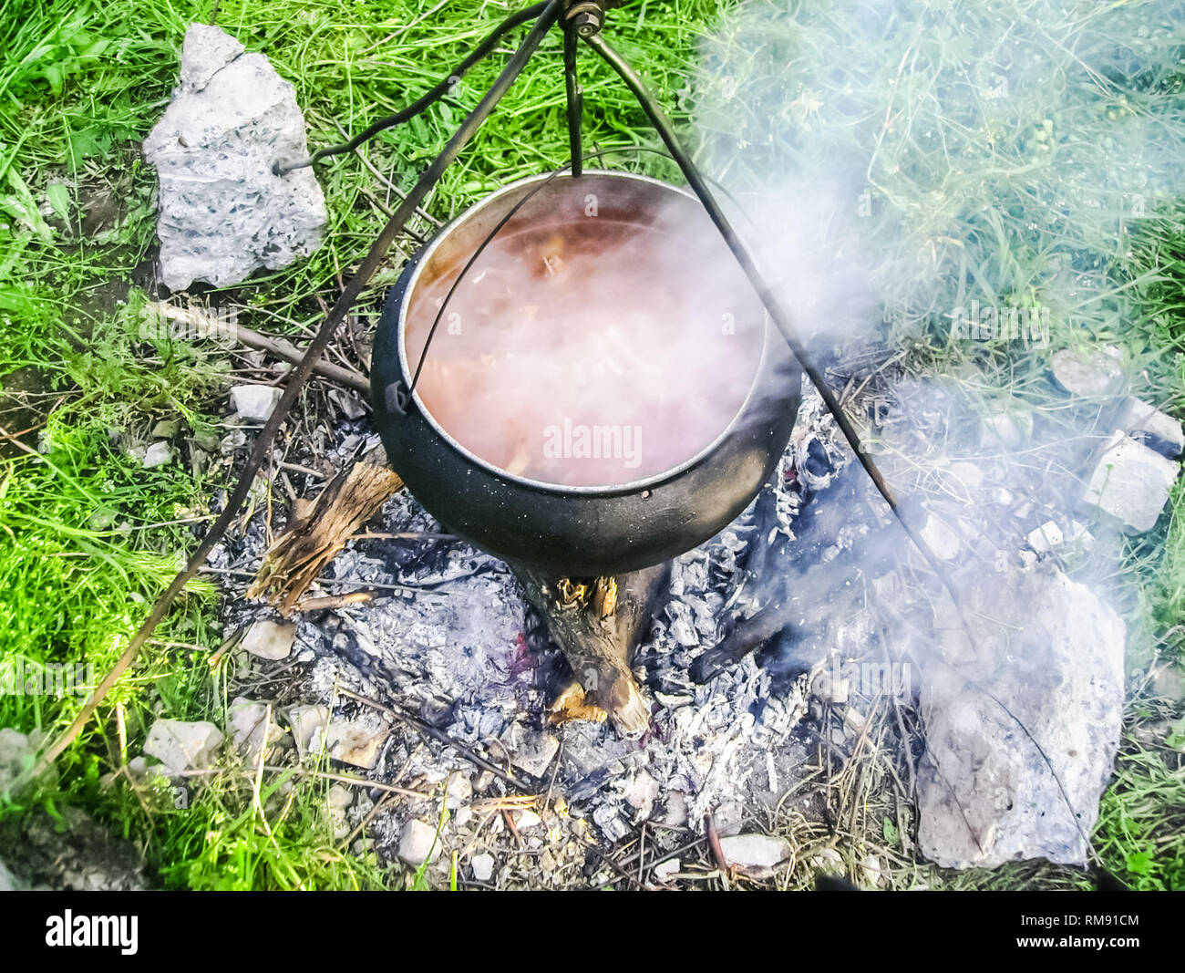 Cooking food on the fire in the pot. Cooking food on the fire in the ...