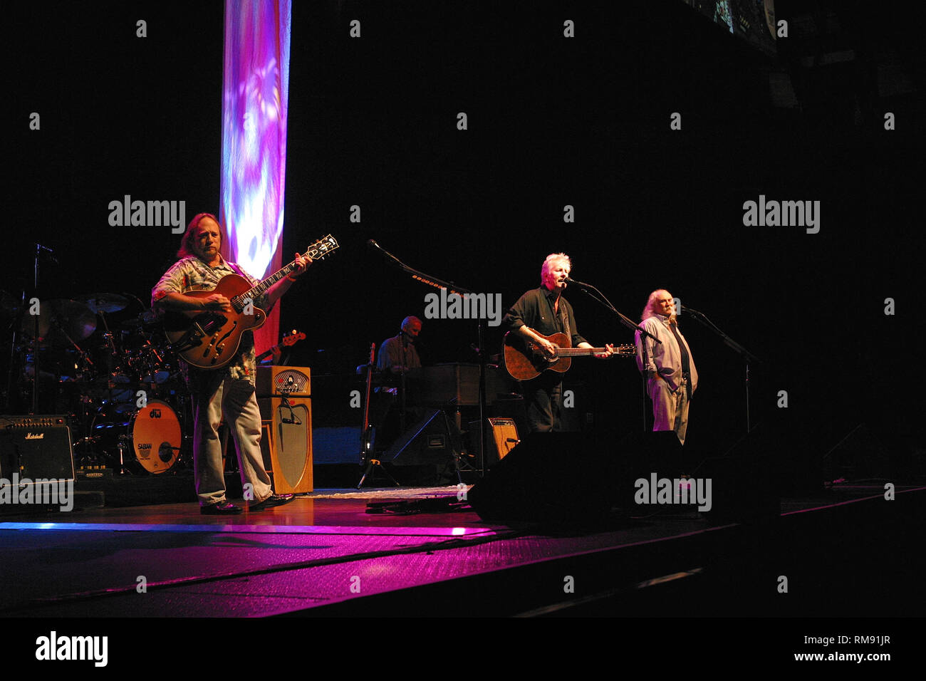 Stephen Stills, Graham Nash and David Crosby are shown performing on ...