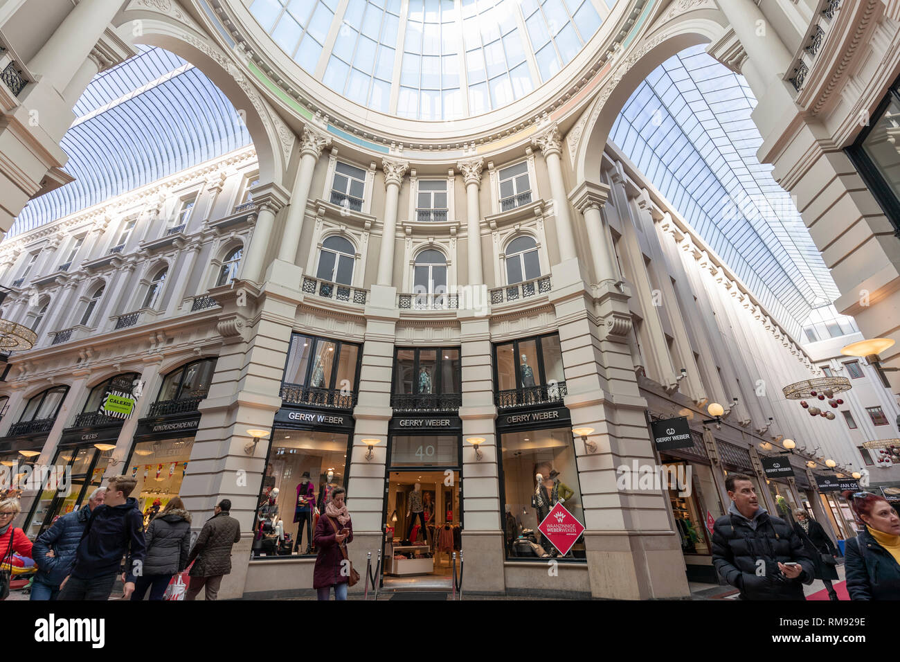 People doing their holiday shopping in a fancy indoor shopping street ...
