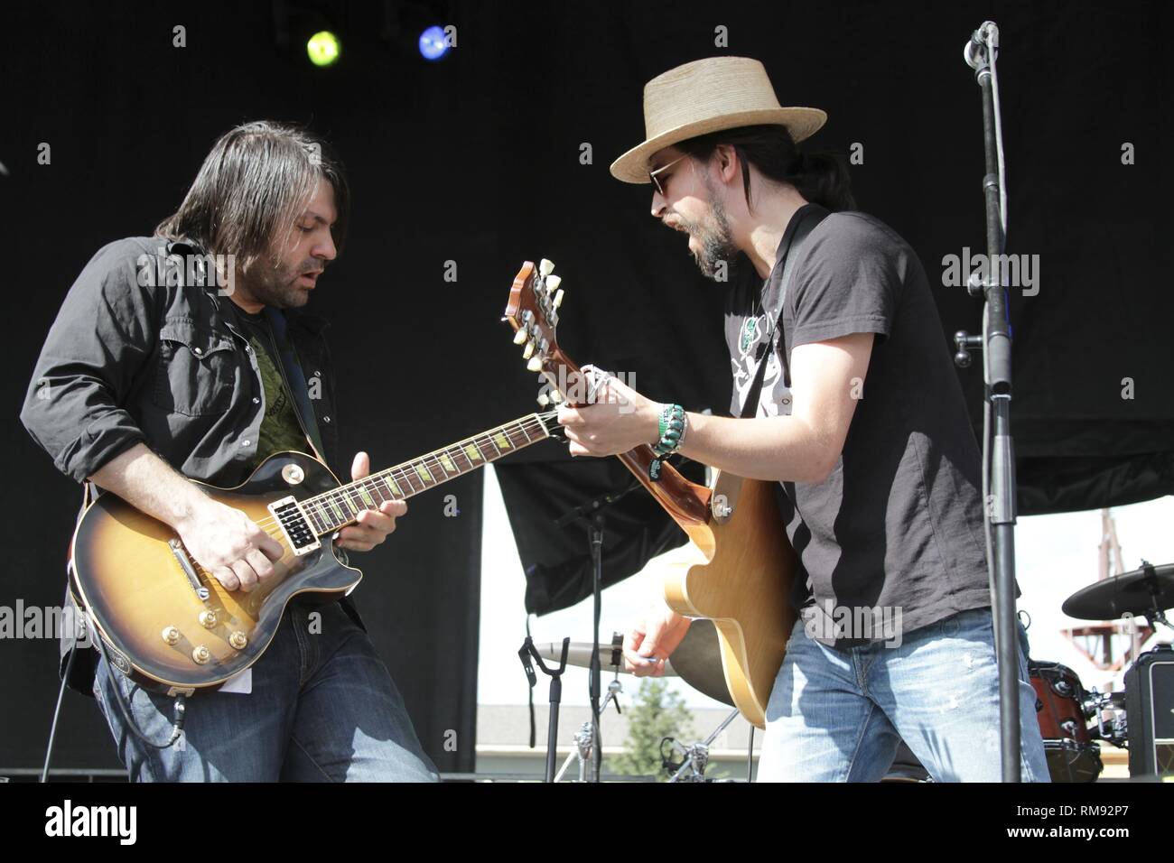 Muscians Nathan Dale and Jackie Greene are shown performing on stage ...