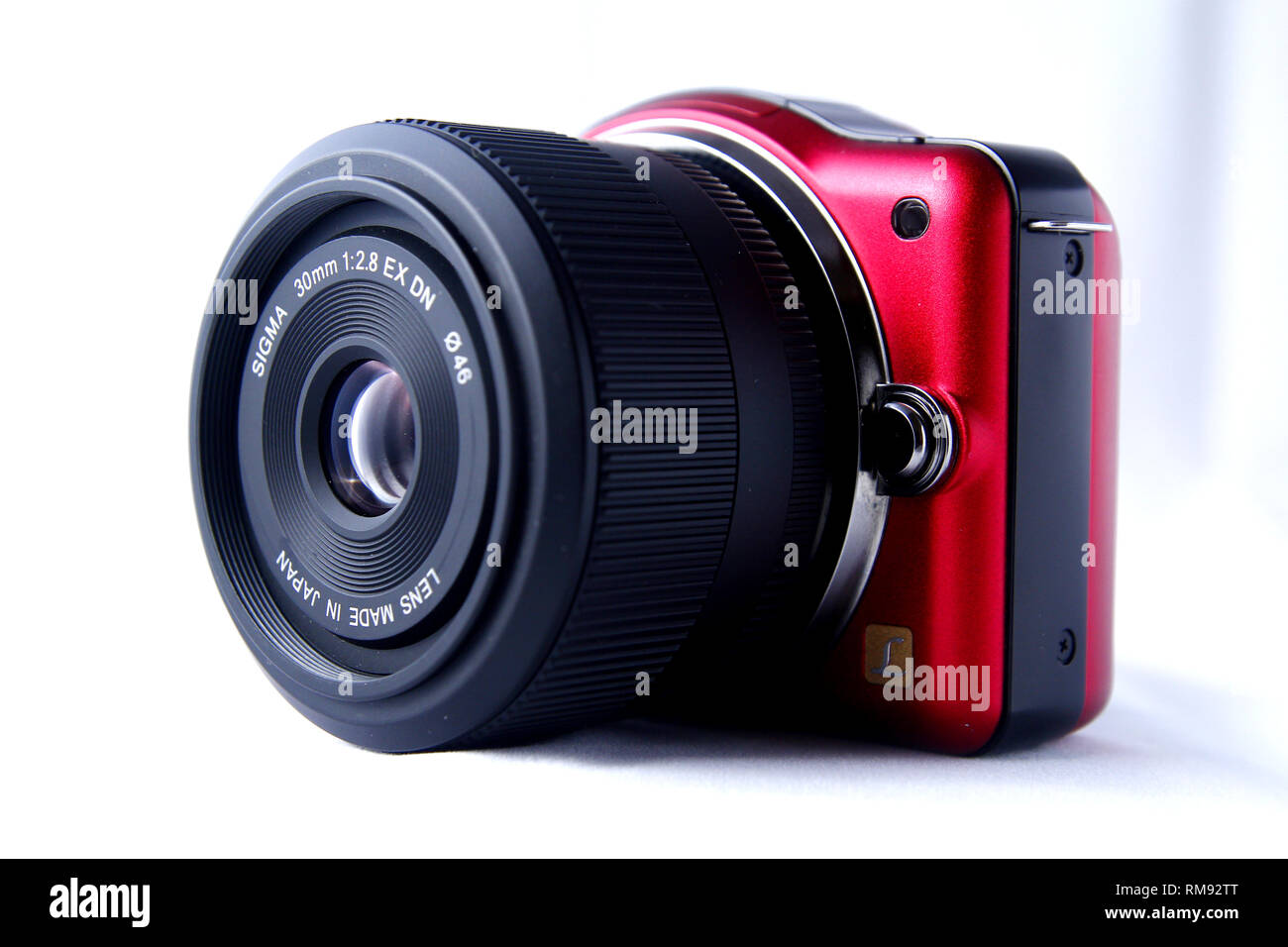 Photo of a red colored digital mirrorless camera Stock Photo - Alamy
