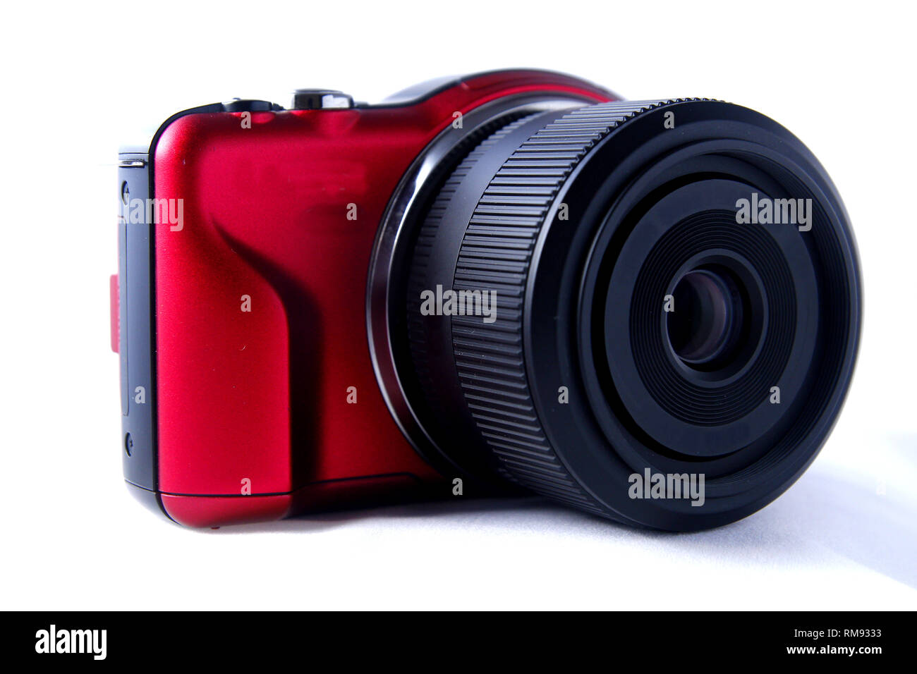 Photo of a red colored digital mirrorless camera Stock Photo - Alamy