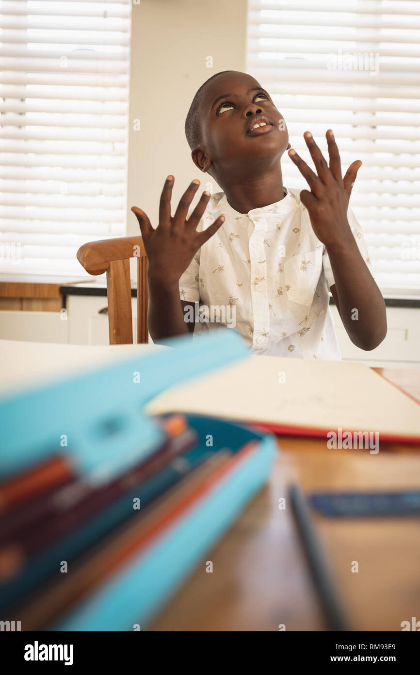 African American boy doing homework on dining table in kitchen Stock ...