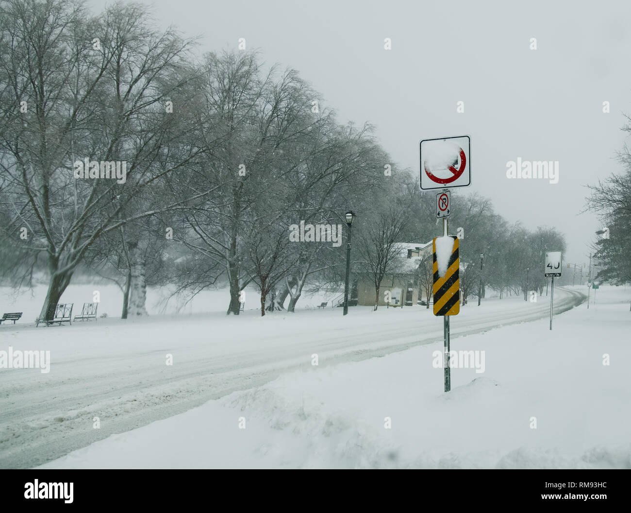 Traffic signs obscured by snow in Stratford, Ontario Stock Photo - Alamy