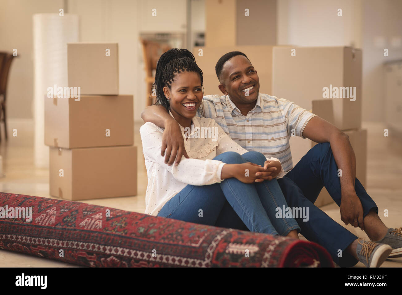 Sitting looking away smiling arm around hi-res stock photography and ...