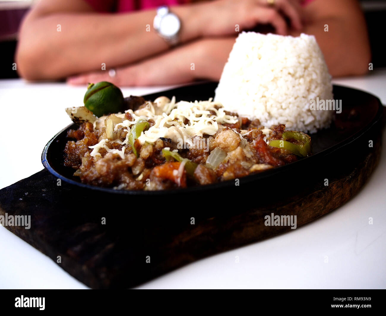 Photo of freshly cooked Filipino dish called Sisig on a hot plate Stock ...