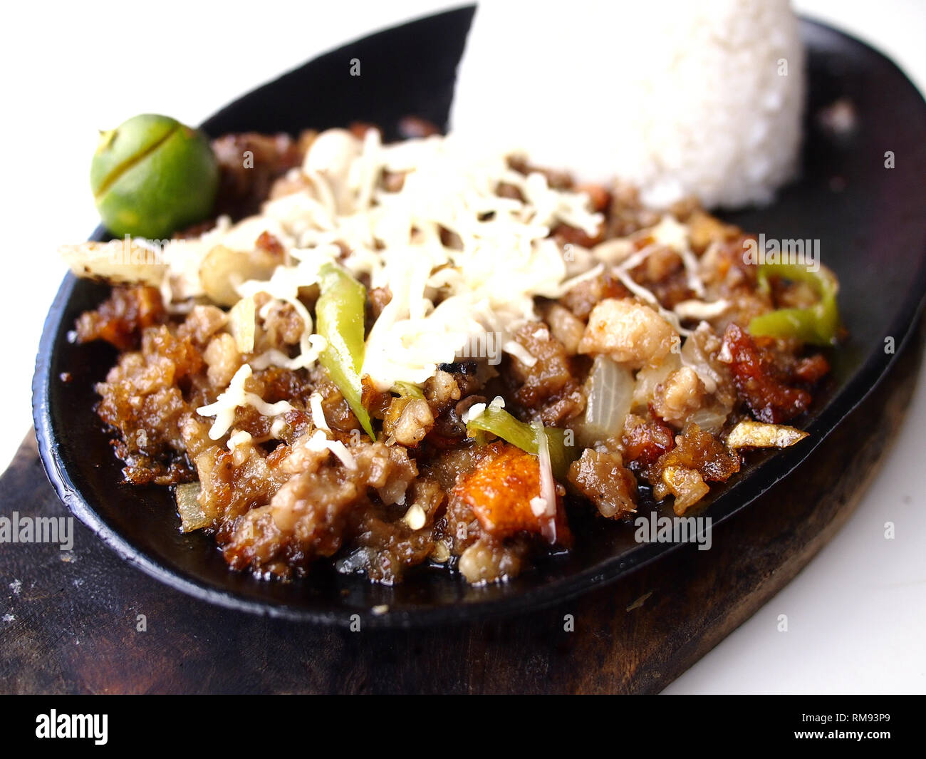 Photo of freshly cooked Filipino dish called Sisig on a hot plate Stock ...