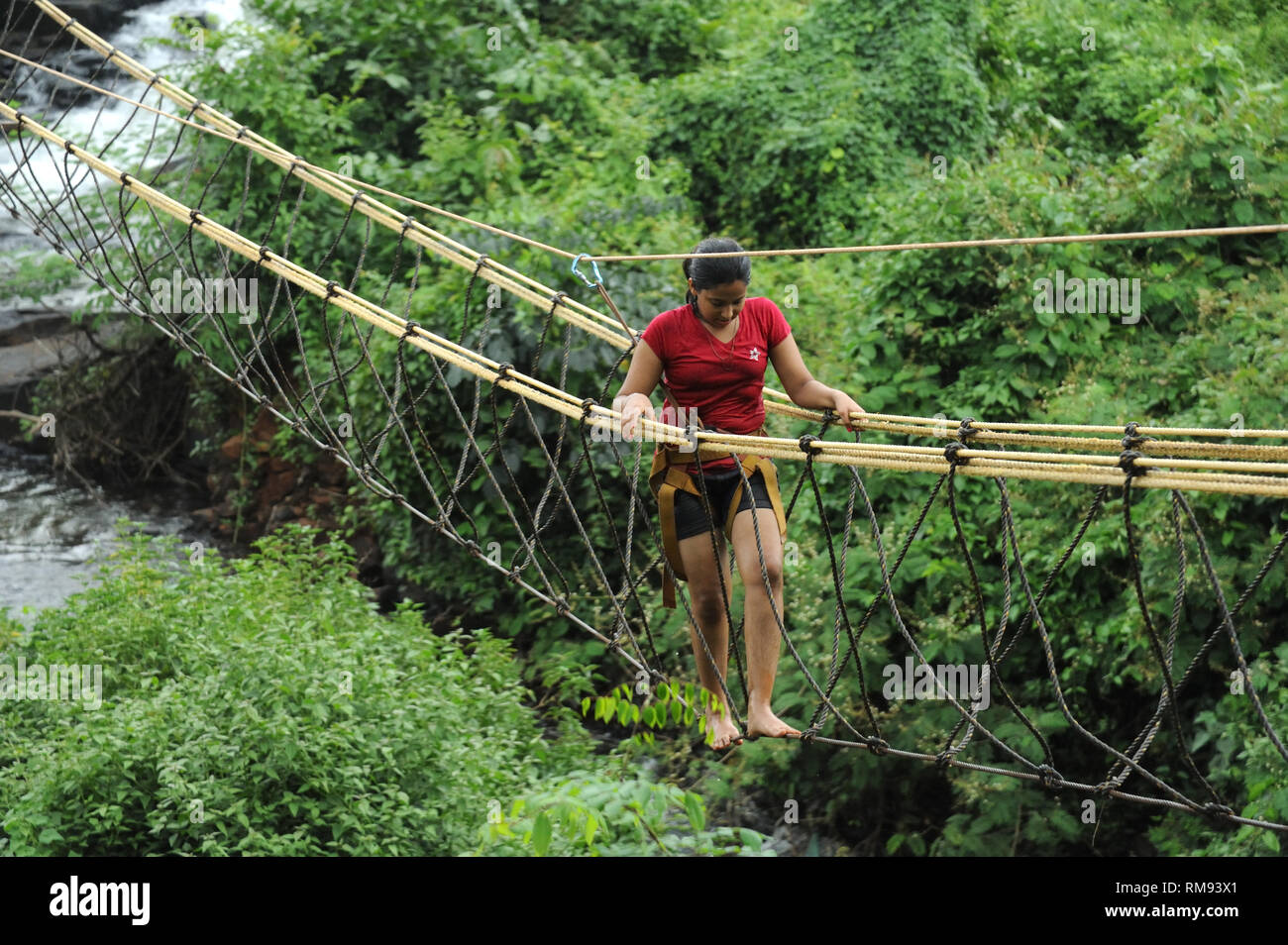 Young girl walking on rope suspension bridge, Kolad, Maharashtra, India ...