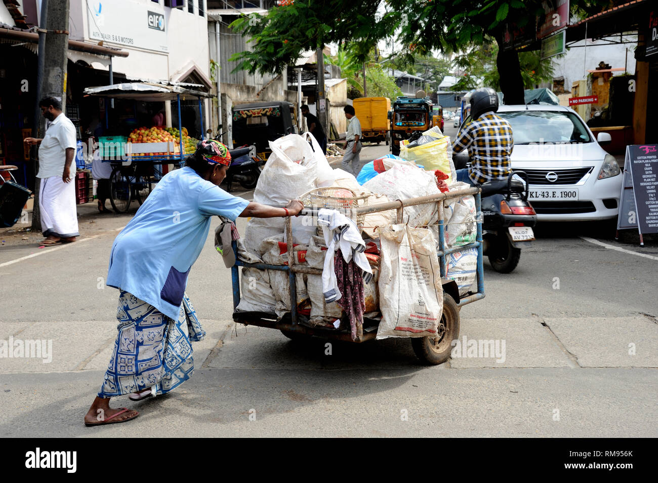 Men pushing handcart hi-res stock photography and images - Alamy