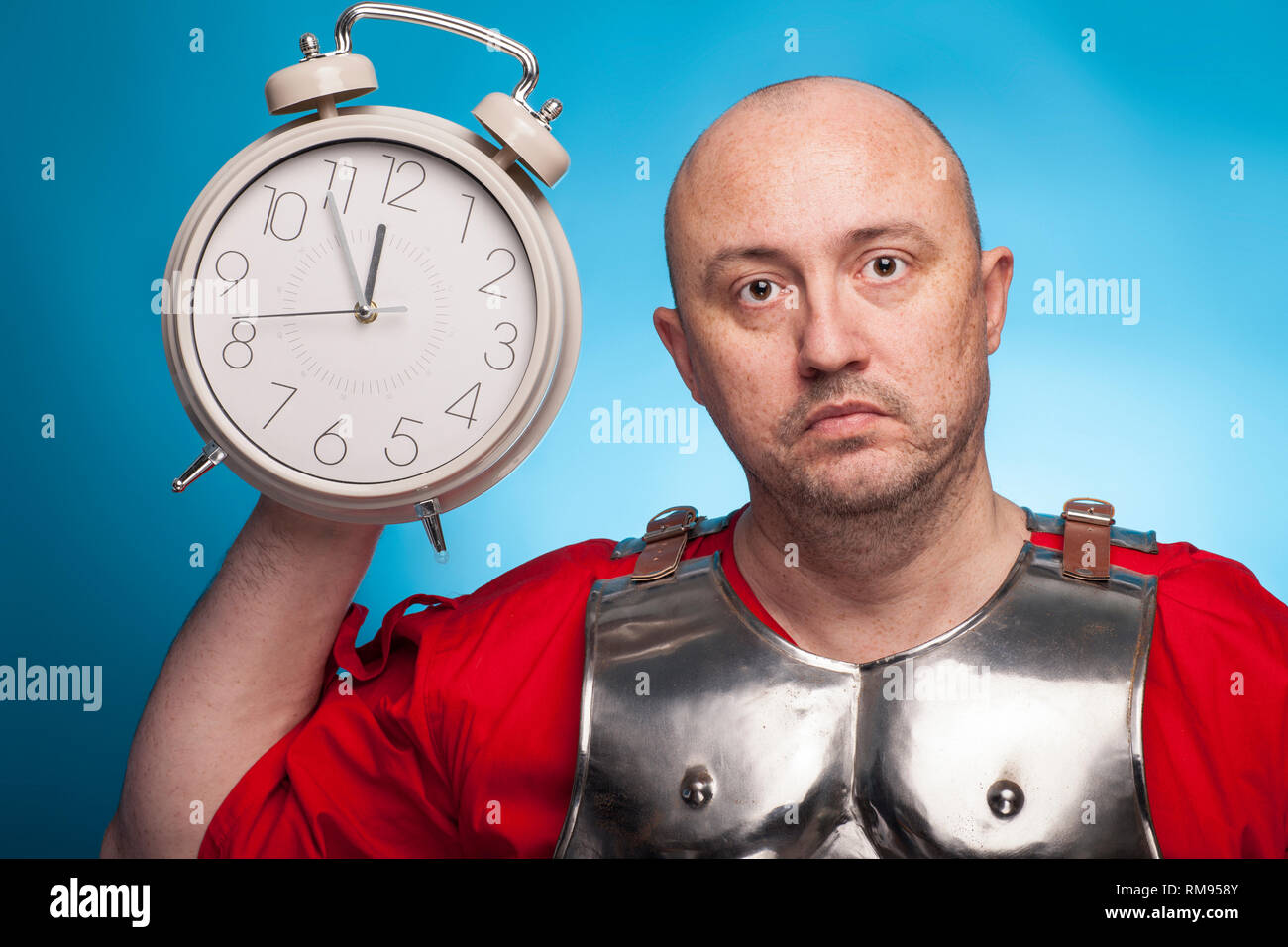 A roman soldier with a big alarm clock on the blue background Stock ...
