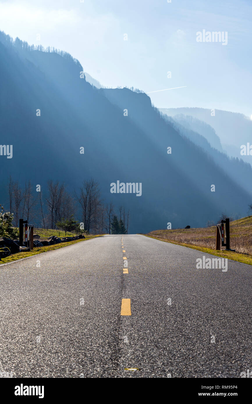 Road with separation marking rests on high mountains on the banks of ...
