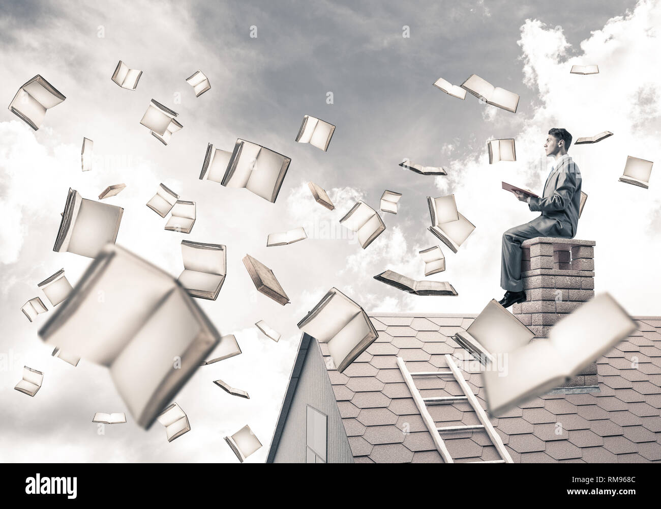 Man reading book and many of them flying in air Stock Photo - Alamy