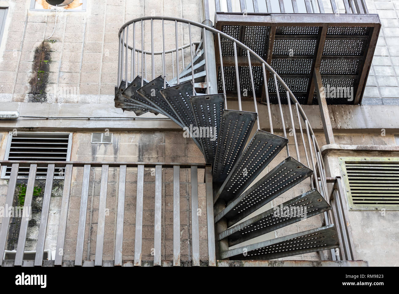Closeup of emergency exit rotating steel stairs outside an old ...