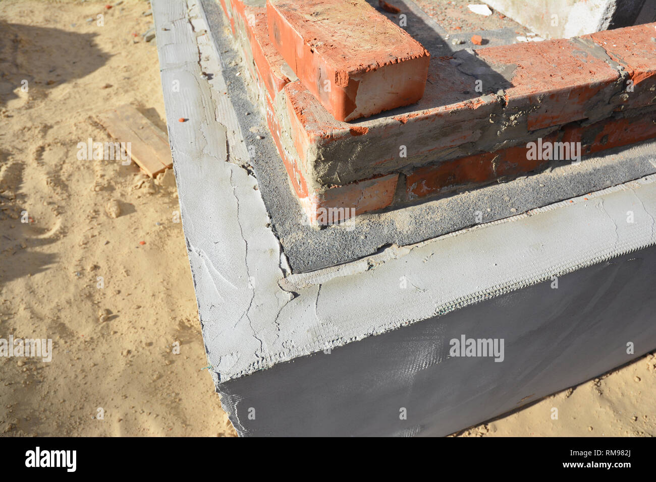 Close up on house foundation wall waterproofing with bitumen membrane ...