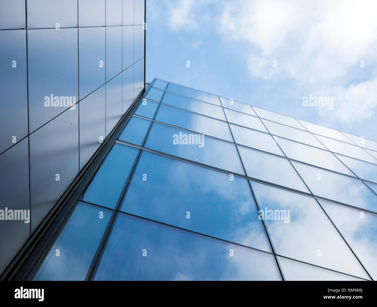 detail of modern office building with glass and steel reflecting blue ...