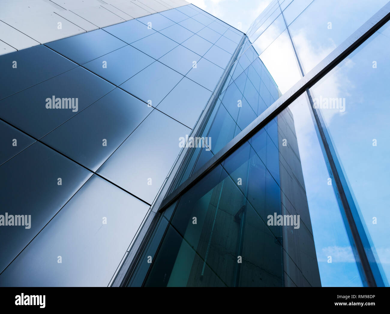 detail of modern office building with glass and steel reflecting blue ...
