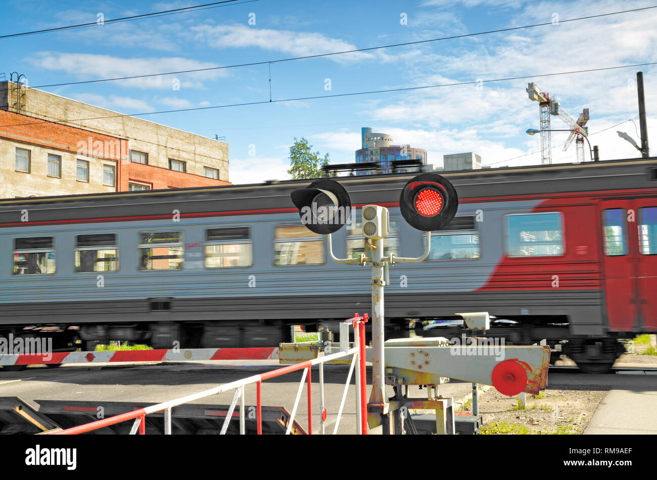 A passenger train moves along the route.And the railway crossing was ...