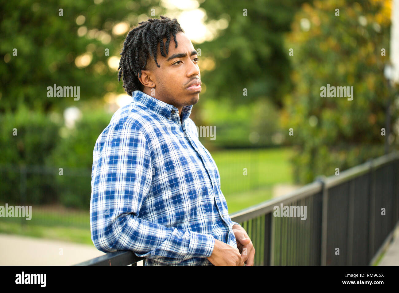 Young man looking concerned and in deep thought Stock Photo - Alamy