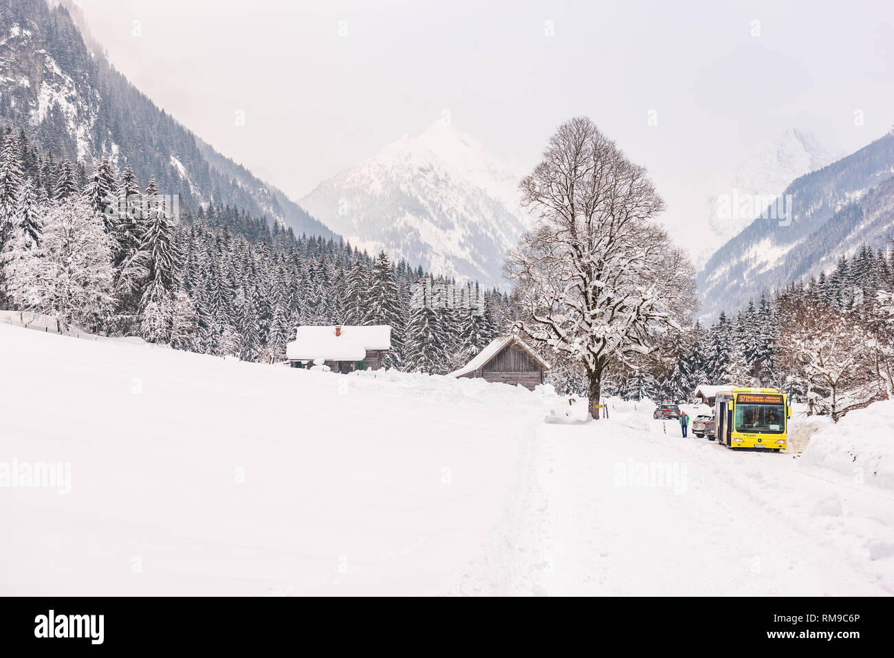 Austrian yellow Mercedes bus at bus stop in ski region Schladming ...